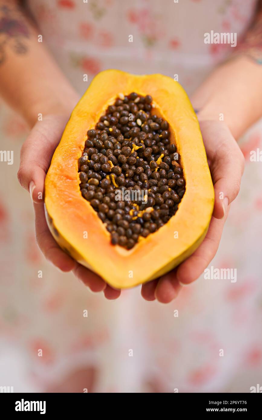Fruit of the angels. half a papaya in a persons hands Stock Photo - Alamy