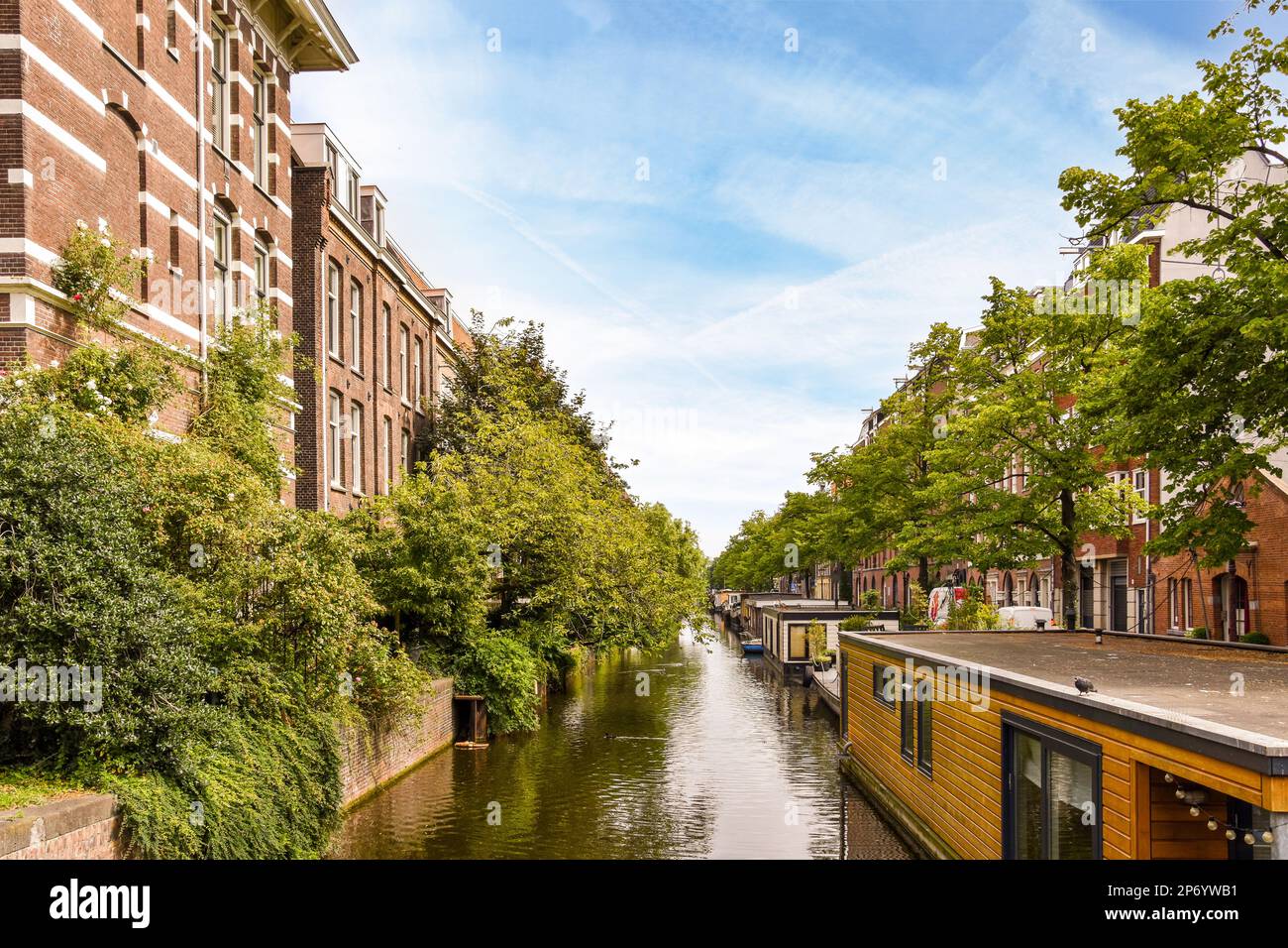 a canal with buildings in the background and trees lining the side of ...