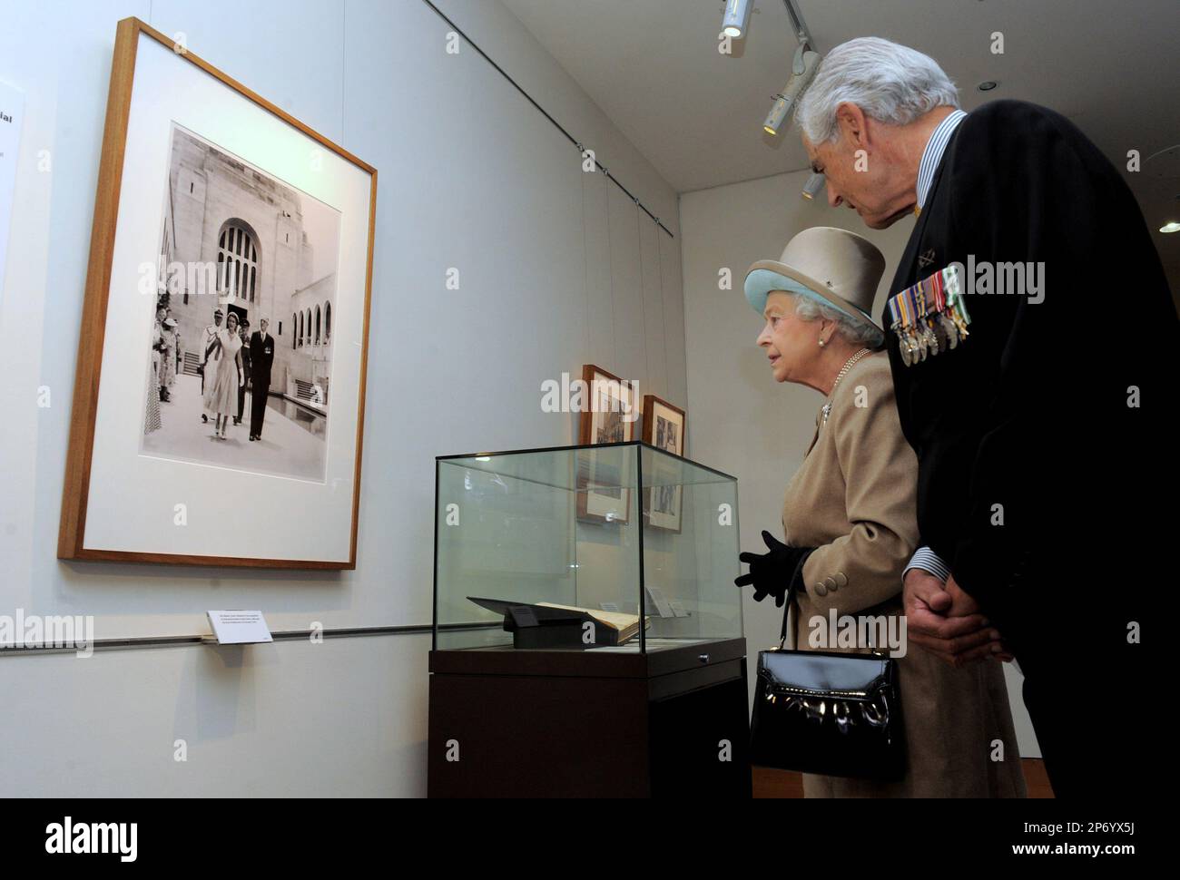 Queen Elizabeth II, left, views a display including a photograph of her ...