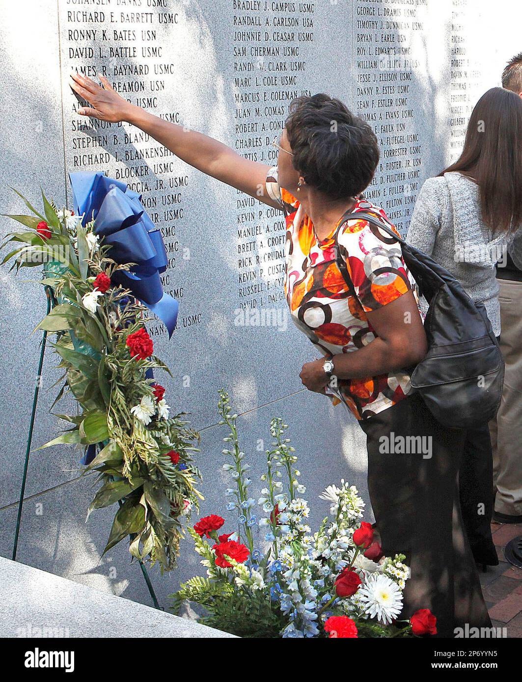 Thomasine Baynard from Richmond, Va., touches her husbands name, James ...