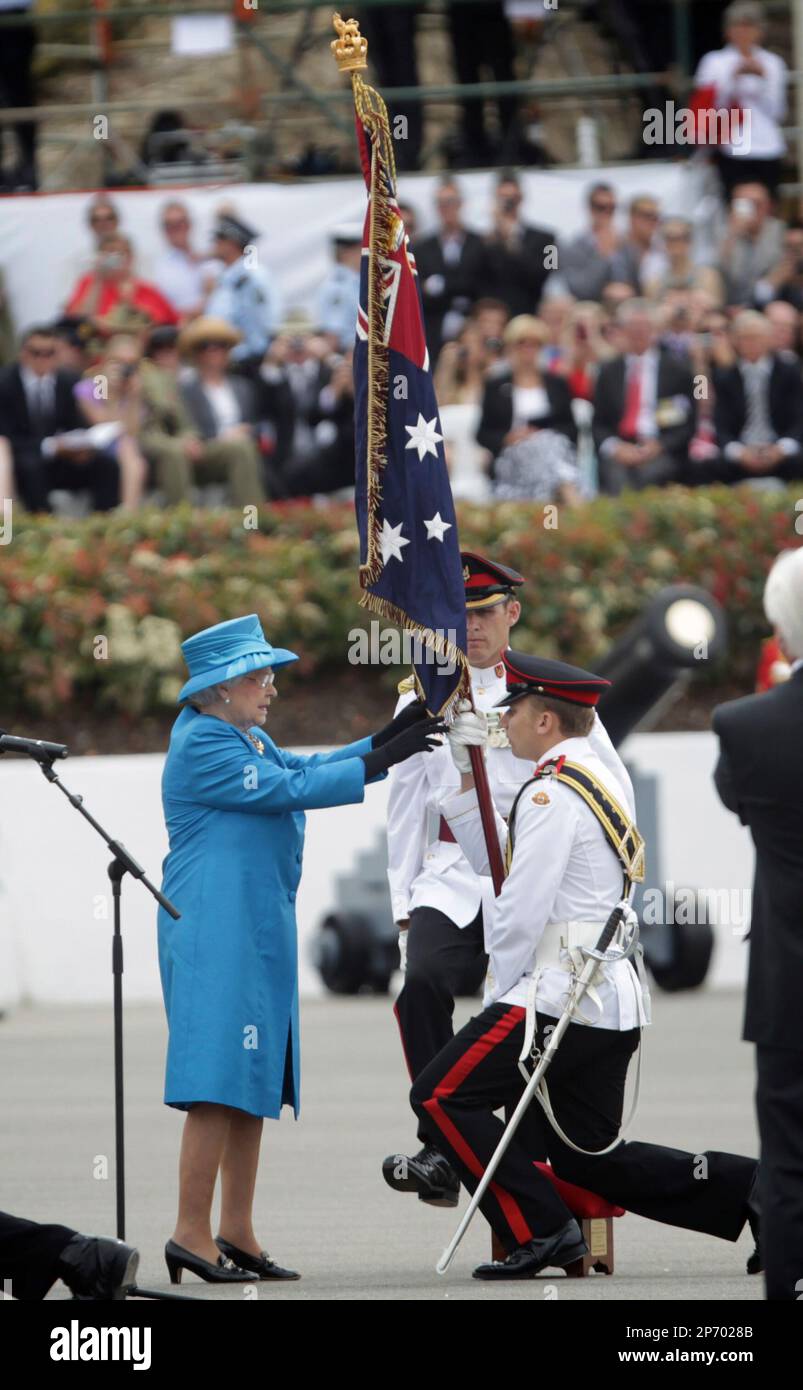Queen Elizabeth II, left, presents the colors at the Royal Military ...