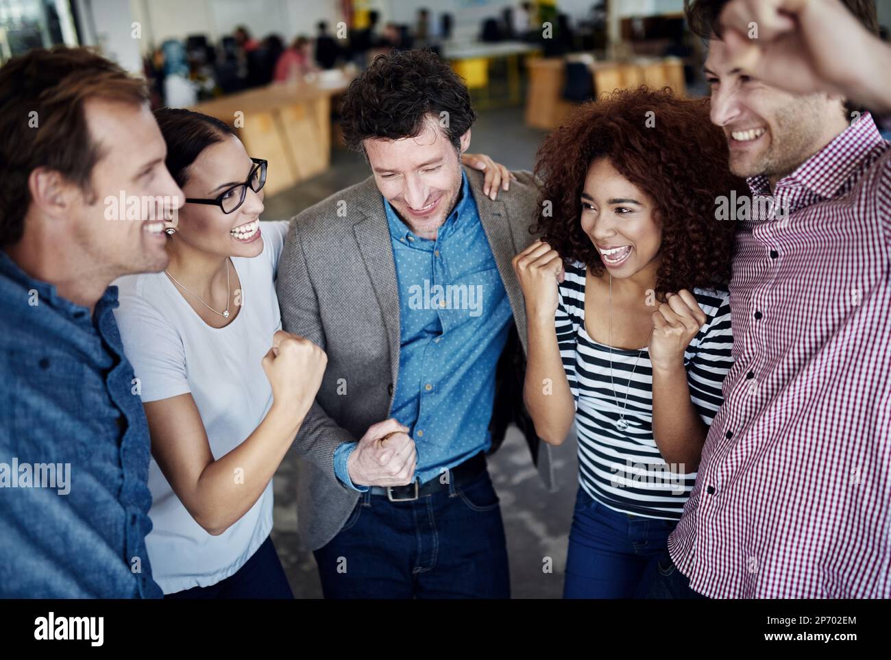 Celebrating another team success. a group of coworkers celebrating ...