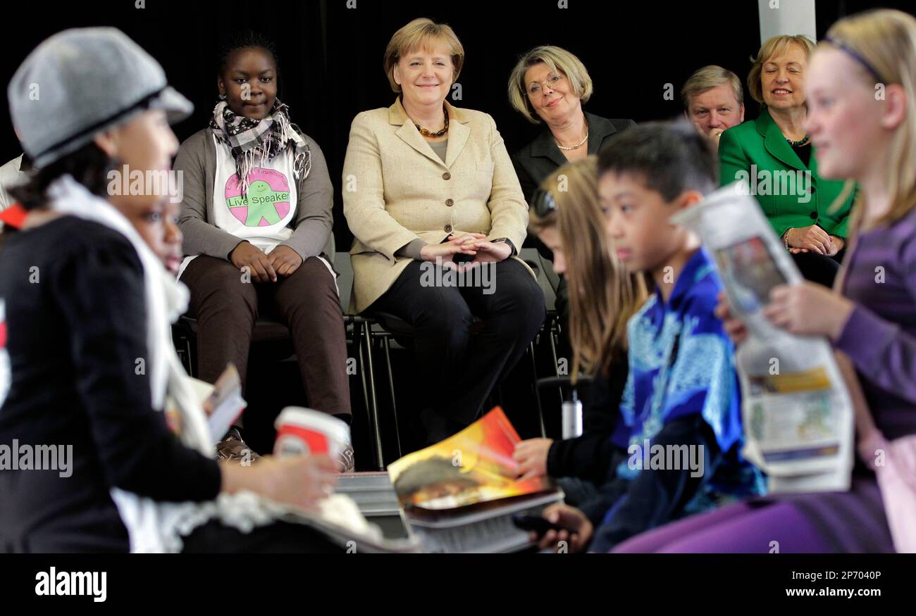 German Chancellor Angela Merkel, center, attends a theatre play during ...
