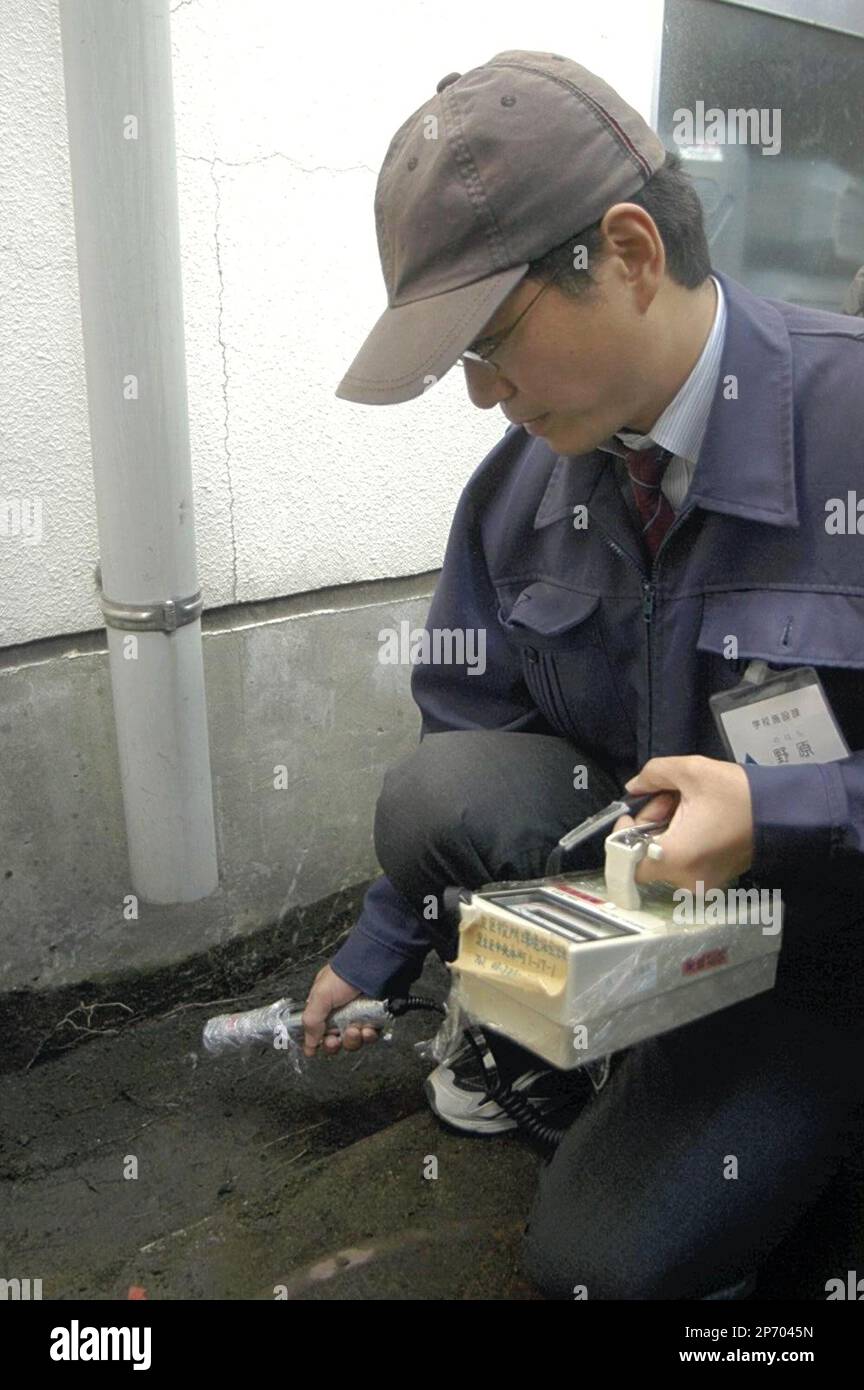 An official of Adachi Ward, measures radiation level during ...