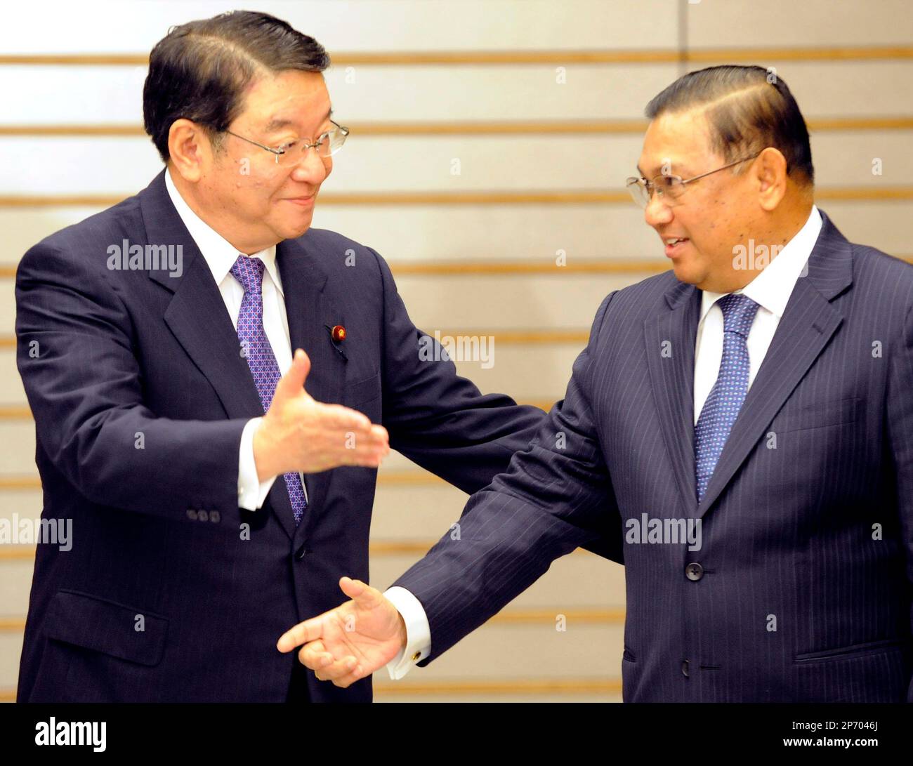 Myanmar's Foreign Minister Wunna Maung Lwin, right, is welcomed by ...
