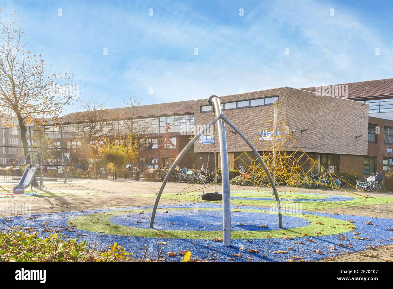an empty playground in the middle of a school with children playing on ...