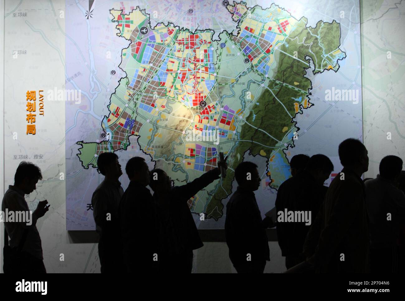 Visitors look at the map of Tianfu New District at the Chengdu Planning ...
