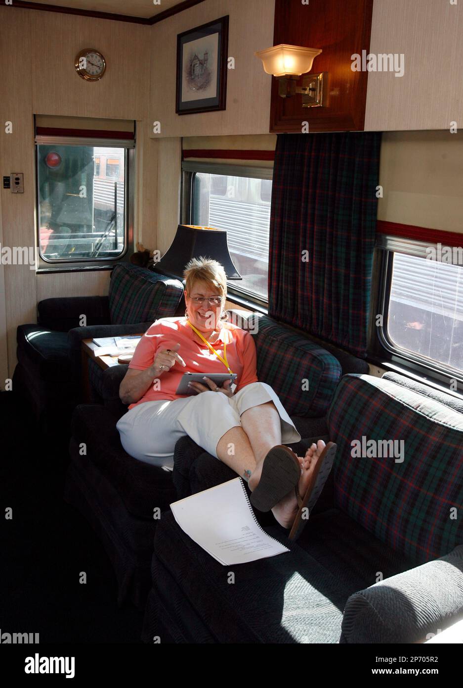 Gayle Creasman, from Orange, California, relaxes with her iPad aboard ...