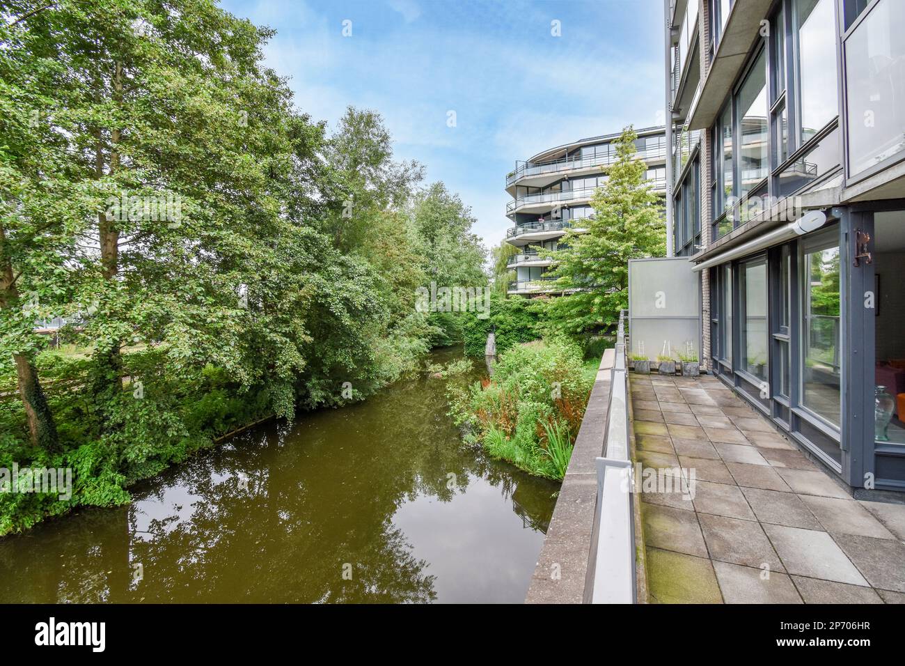 a river in the middle of a city with buildings on both sides and trees ...