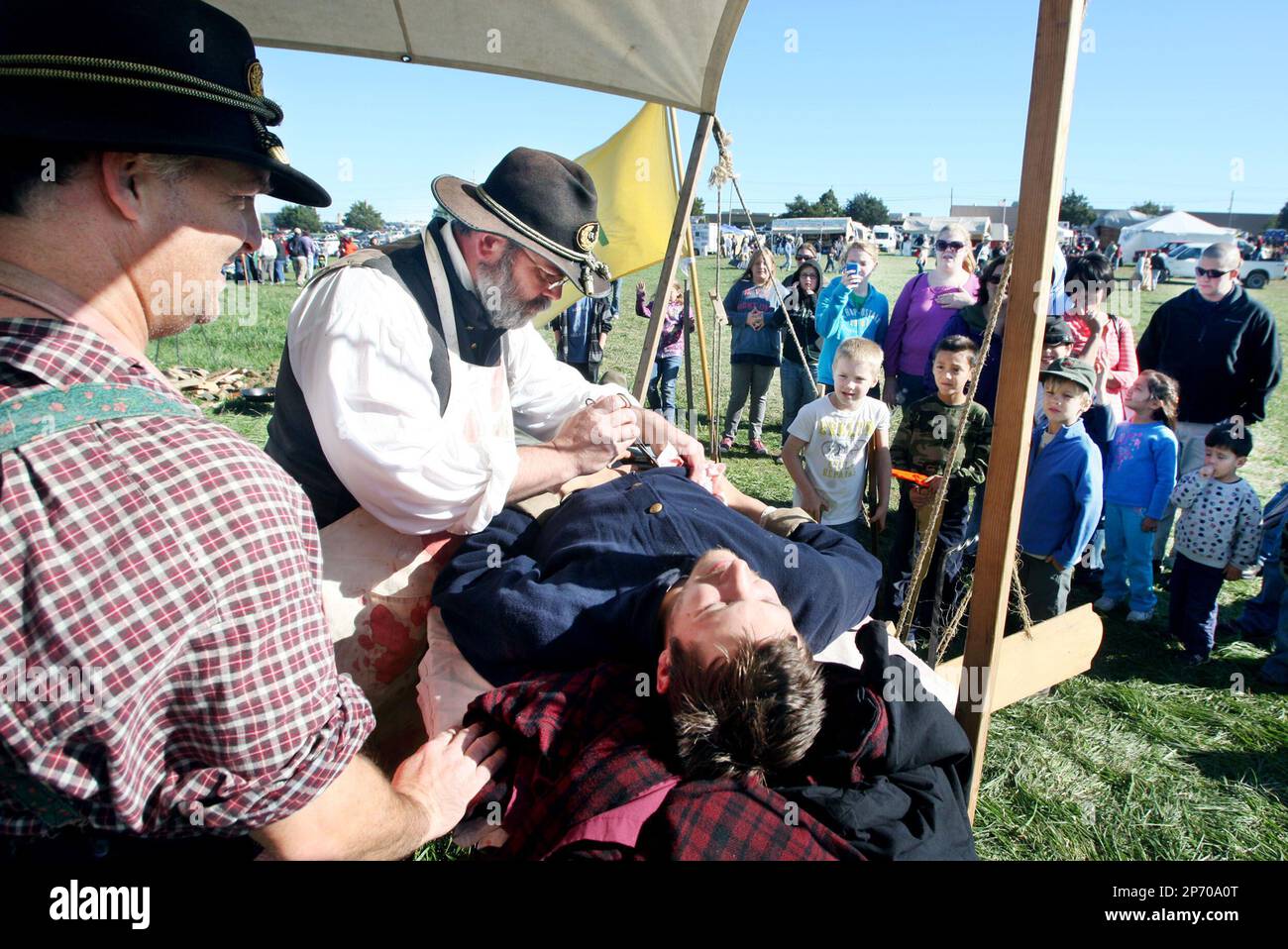 Spectators watch as Civil War reenactors perform a living history ...