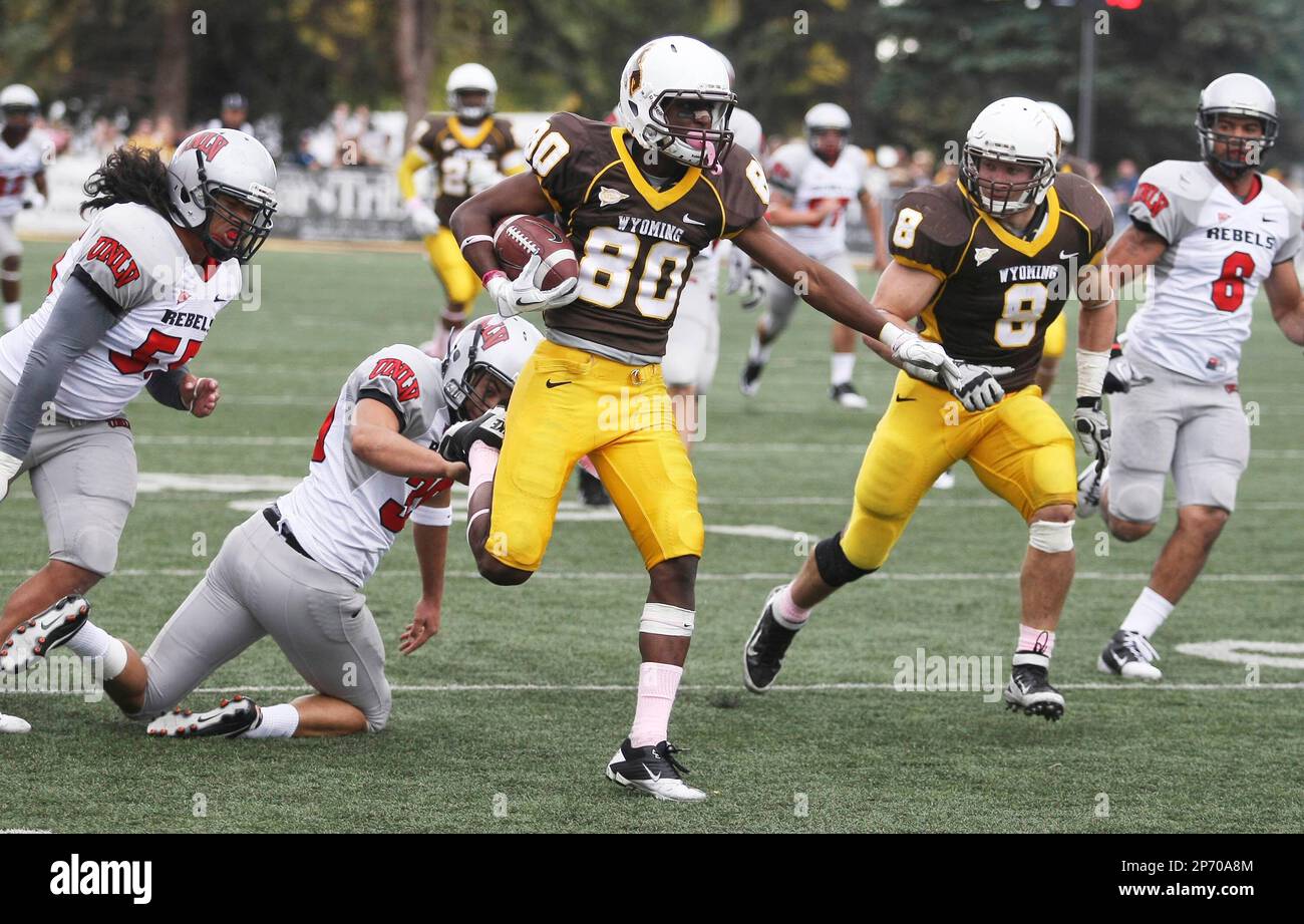 Wyoming receiver Chris McNeil (80) slips a tackle to score on a 75-yard ...