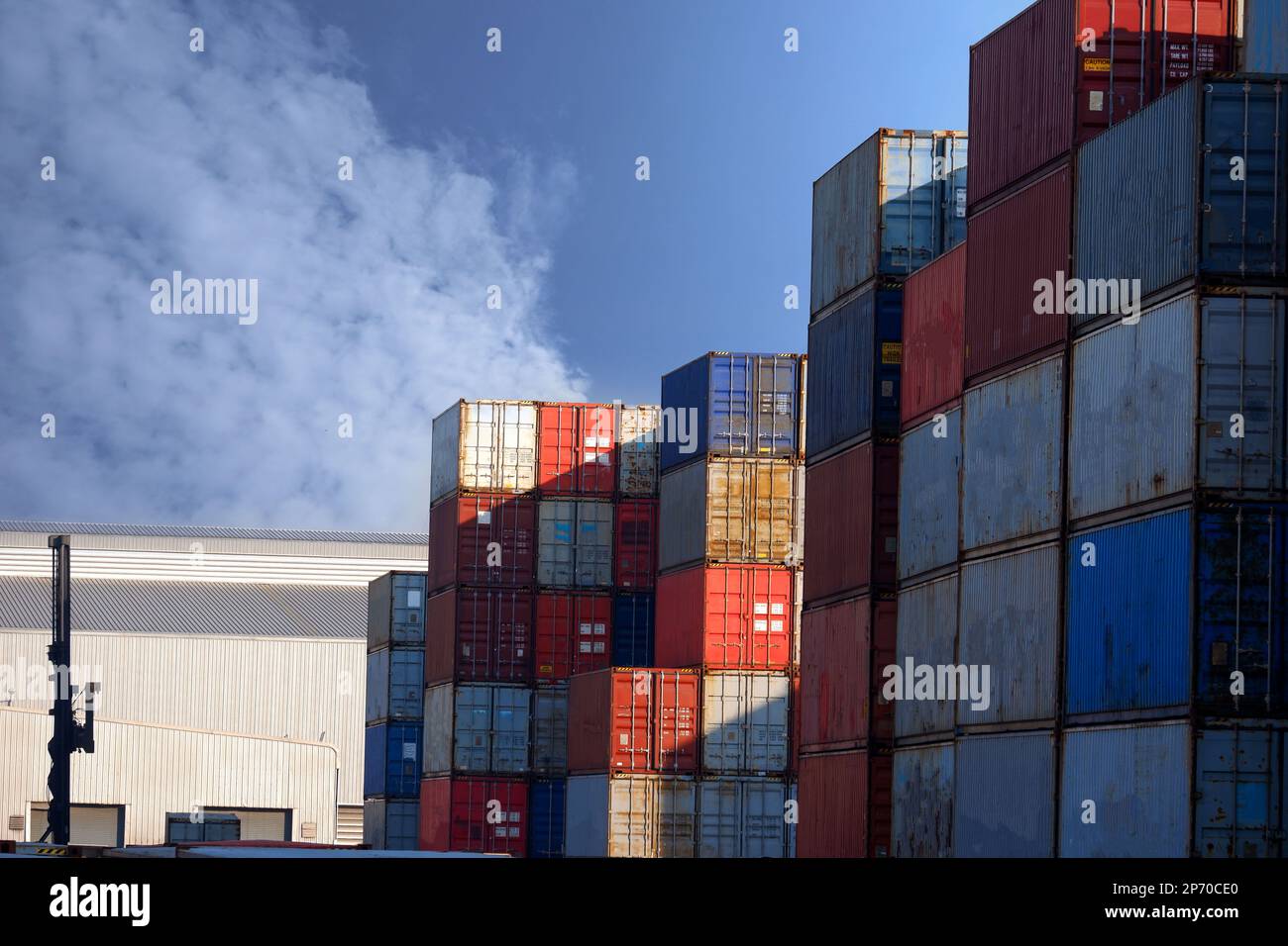 Stacks of cargo containers, import/export ships in port harbour ...