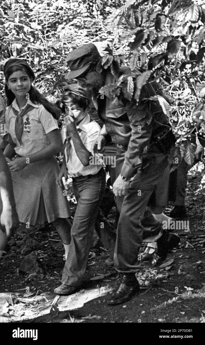 Cuban leader Fidel Castro walks with a group of students during a tour ...