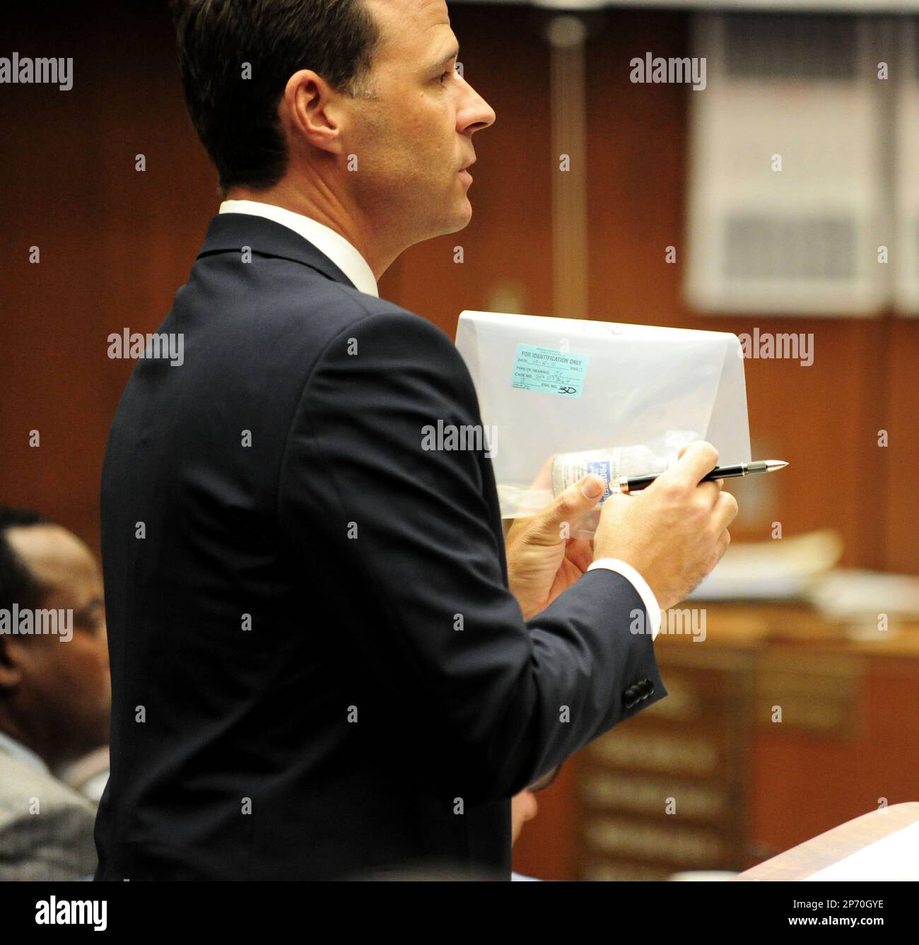 Deputy district attorney David Walgren holds a bottle of propofol while ...