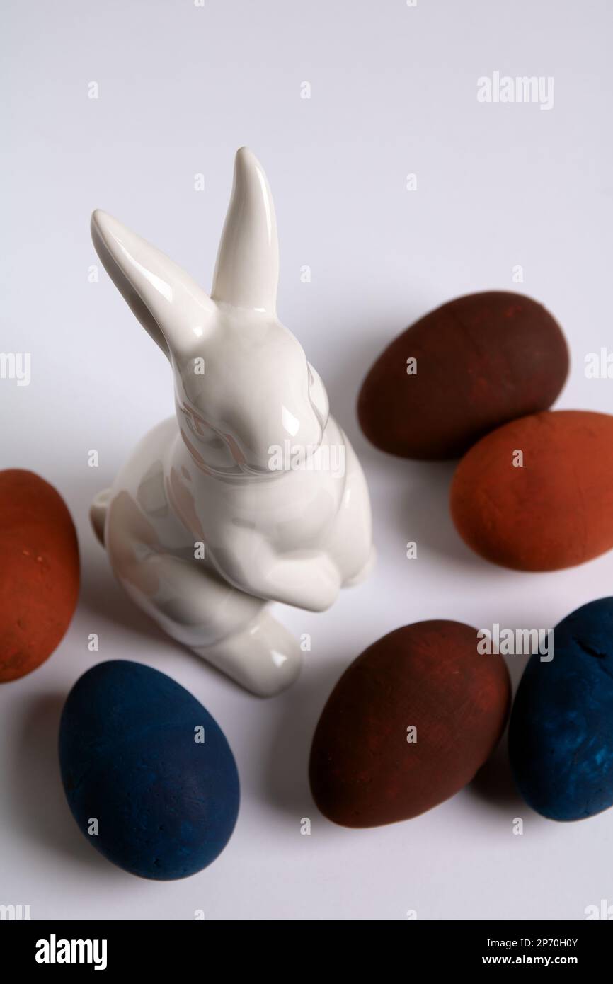 photo of a different color painted egg and a white rabbit on a white ...