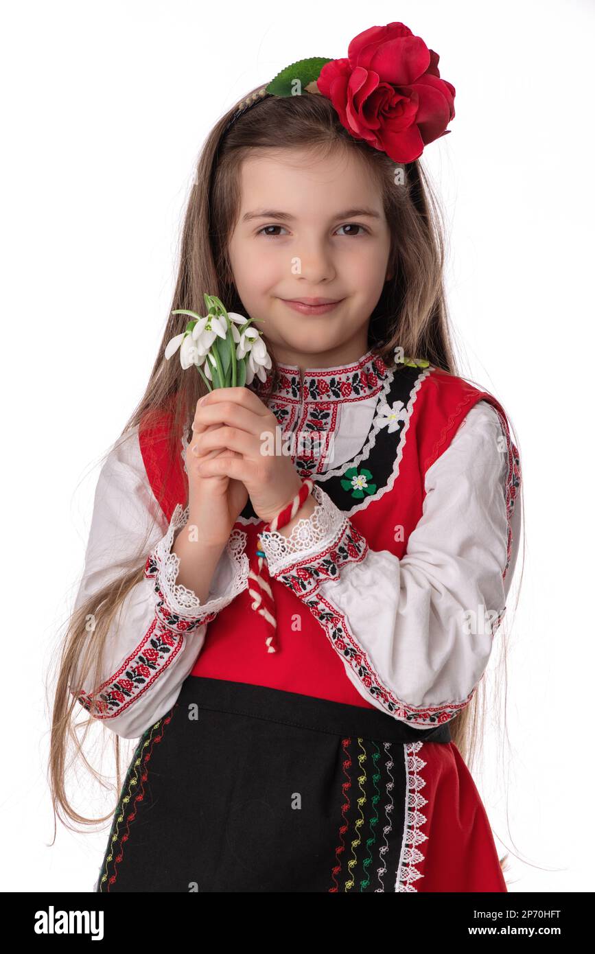 Bulgarian girl in traditional folklore costumes with spring flowers ...