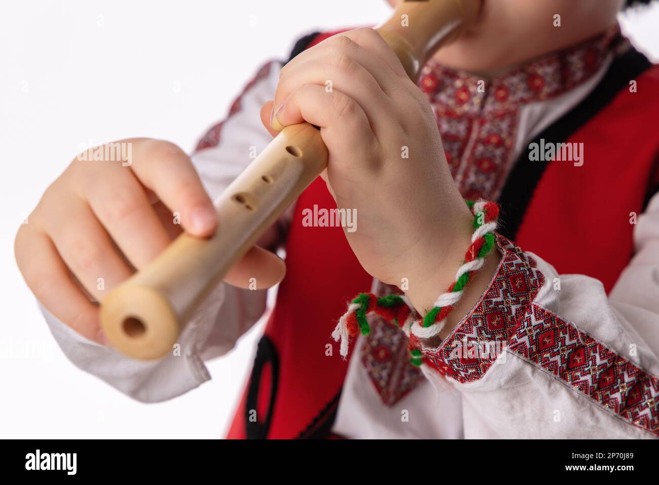 Bulgarian boy in traditional folklore costumes with spring flowers ...