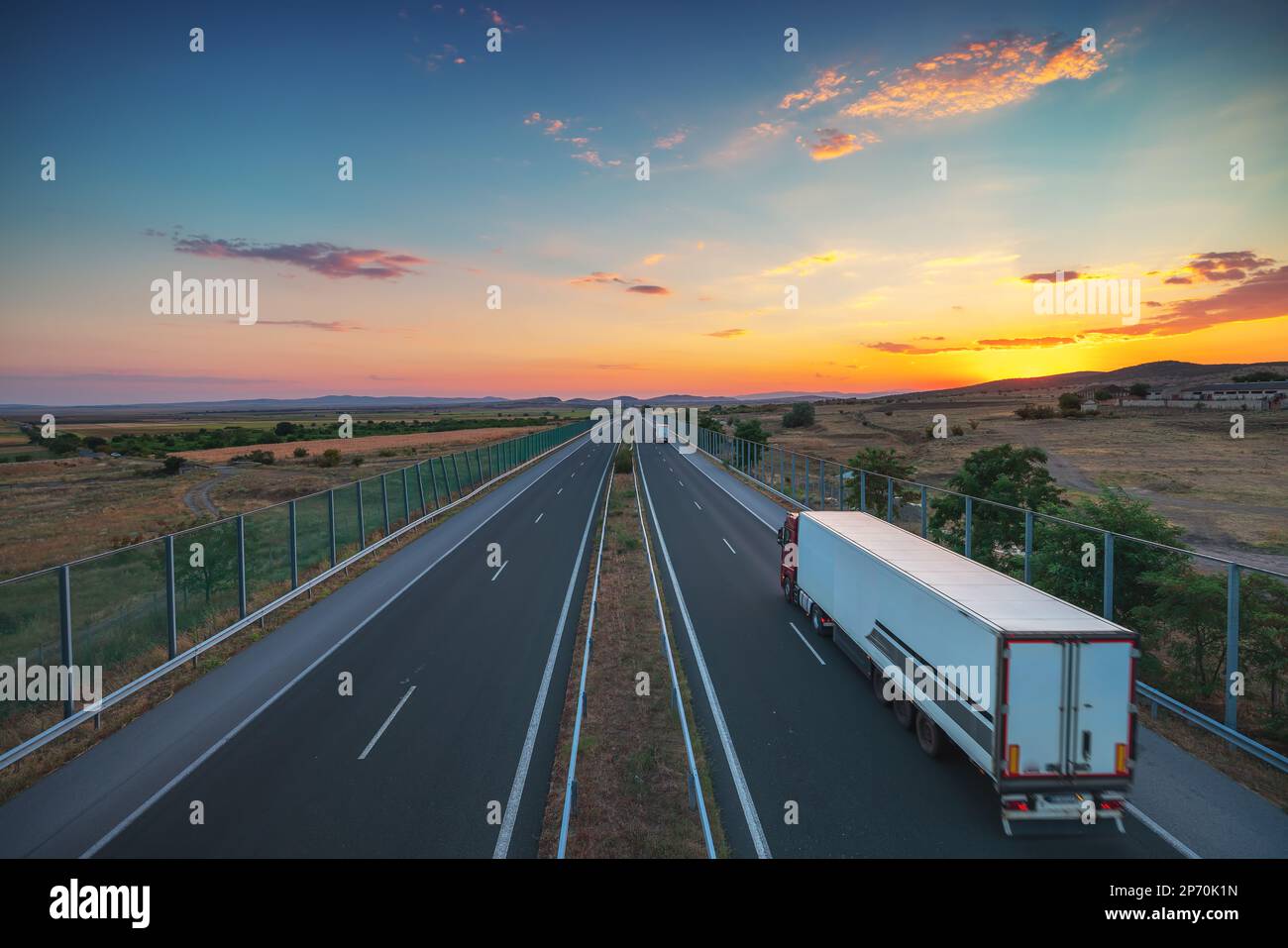 Driving on open road at beautiful sunset. Aerial view Stock Photo - Alamy
