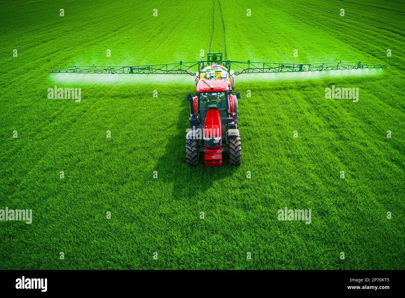 Aerial view of farming tractor plowing and spraying on field Stock ...