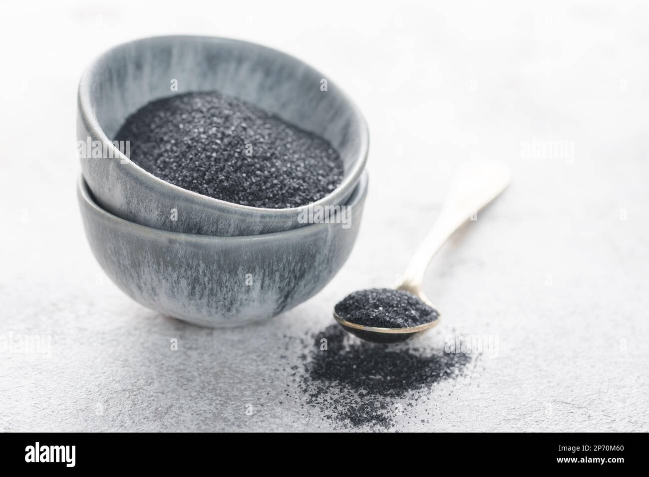 Bowl of Hawaiian black lava sea salt . Healthy food concept. Speciality ...