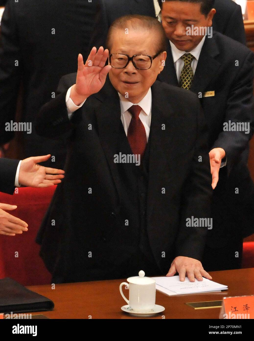 Former Chinese President Jiang Zemin waves his hand to audience at the ...