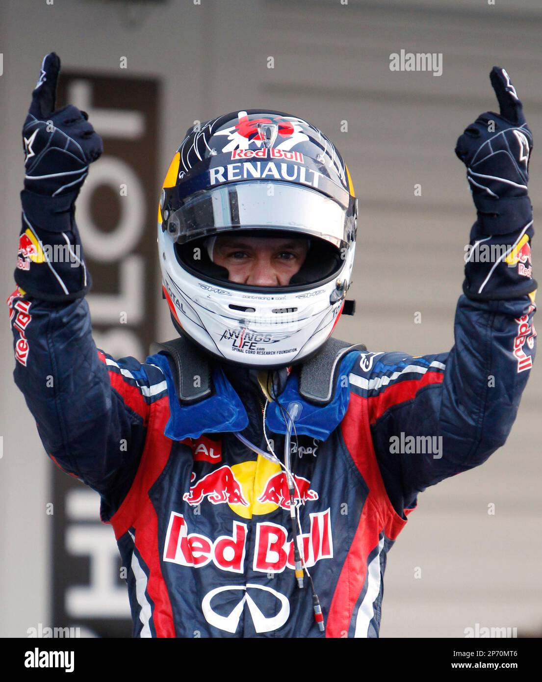 Red Bull driver Sebastian Vettel of Germany shows number one signs ...