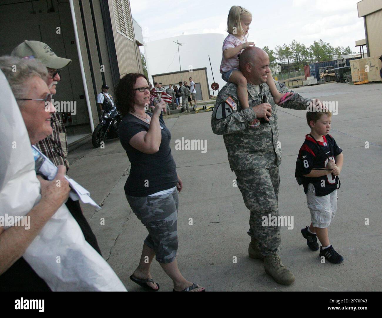 U.S. Army Reserves Spc. Lance Boone walks with his daughter Maggie, 3 ...