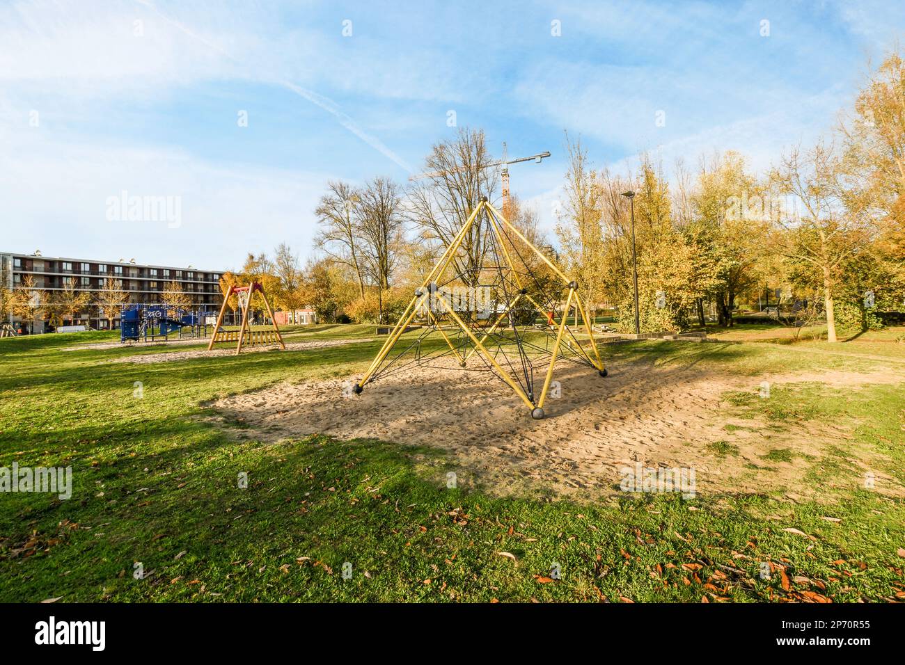 a playground in the middle of an urban park with lots of trees and some ...