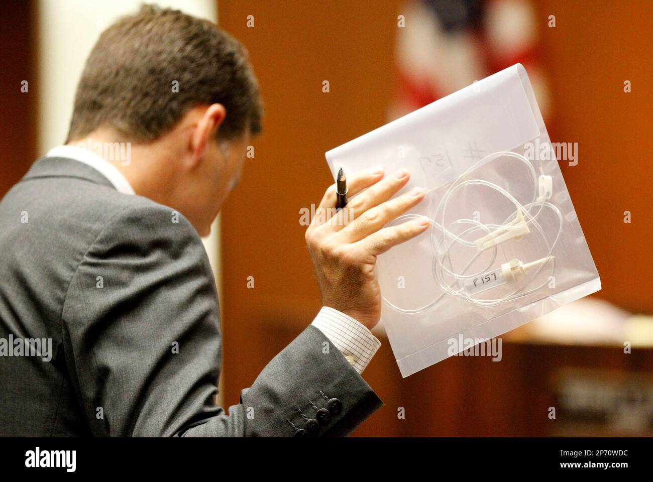 Deputy district attorney David Walgren holds an intravenous line found ...