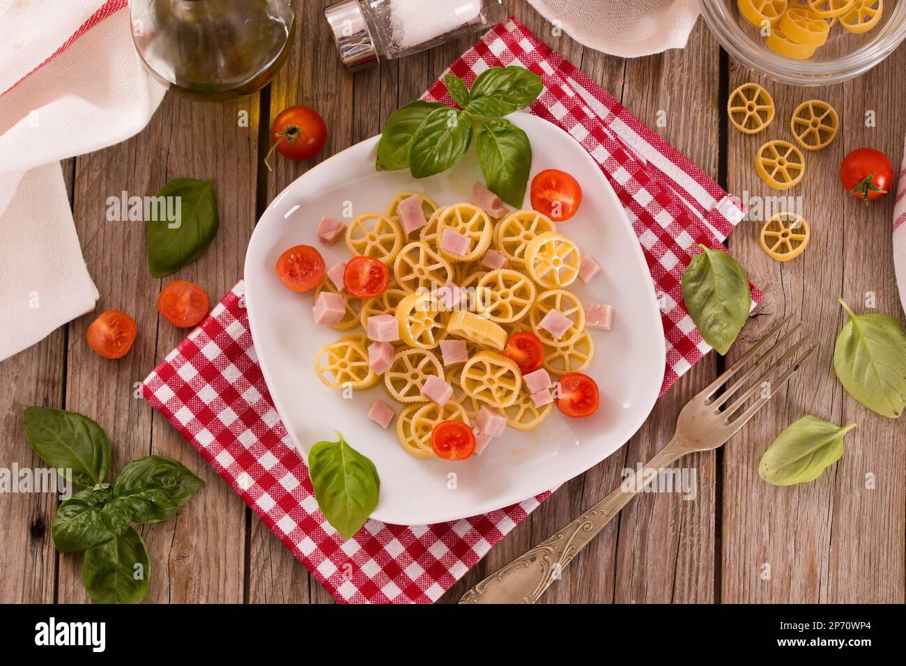 Ruote pasta with tomato and ham Stock Photo - Alamy