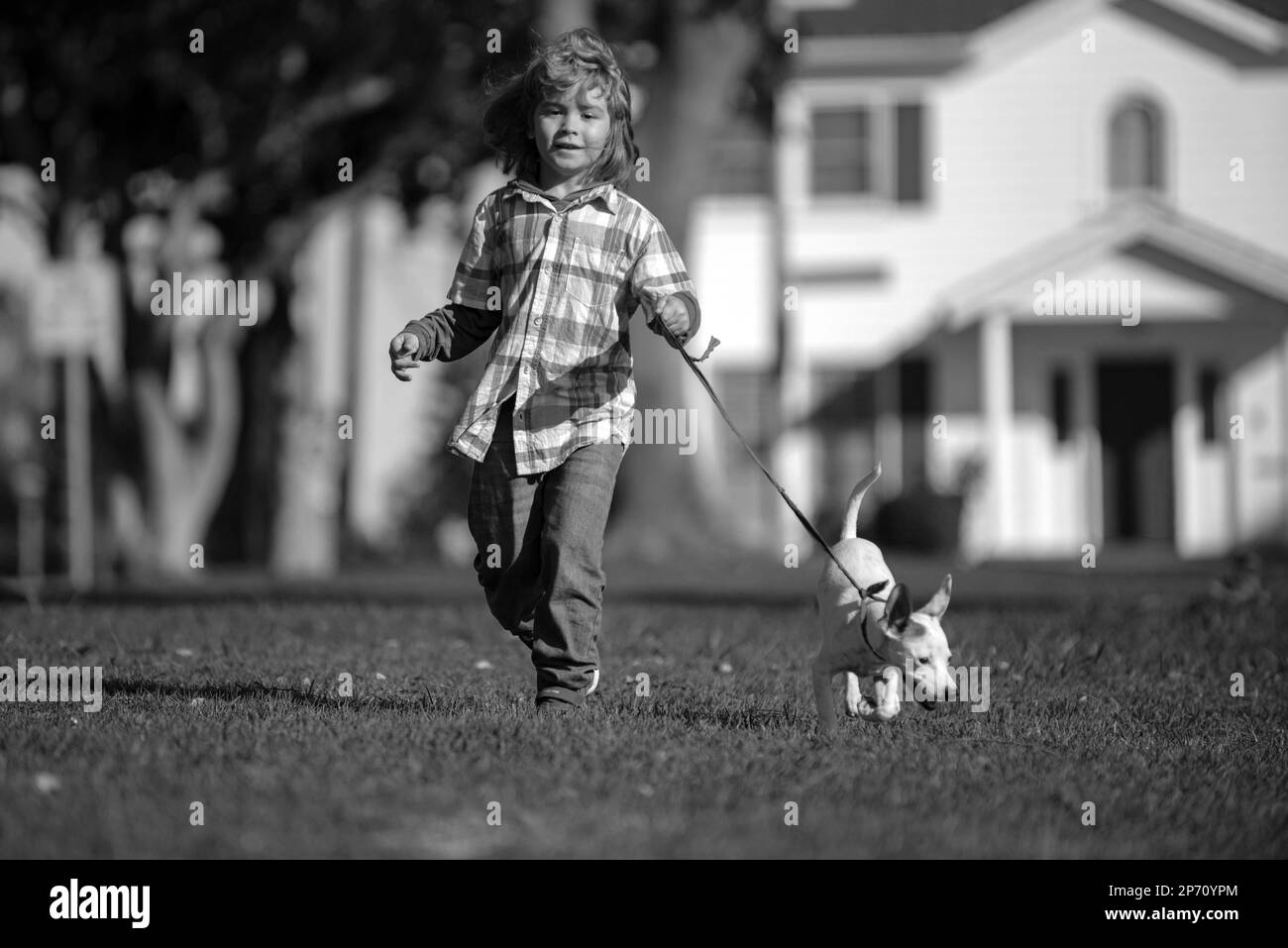 Kids insurance. Little boy kid running with dog, playing owner and pet ...