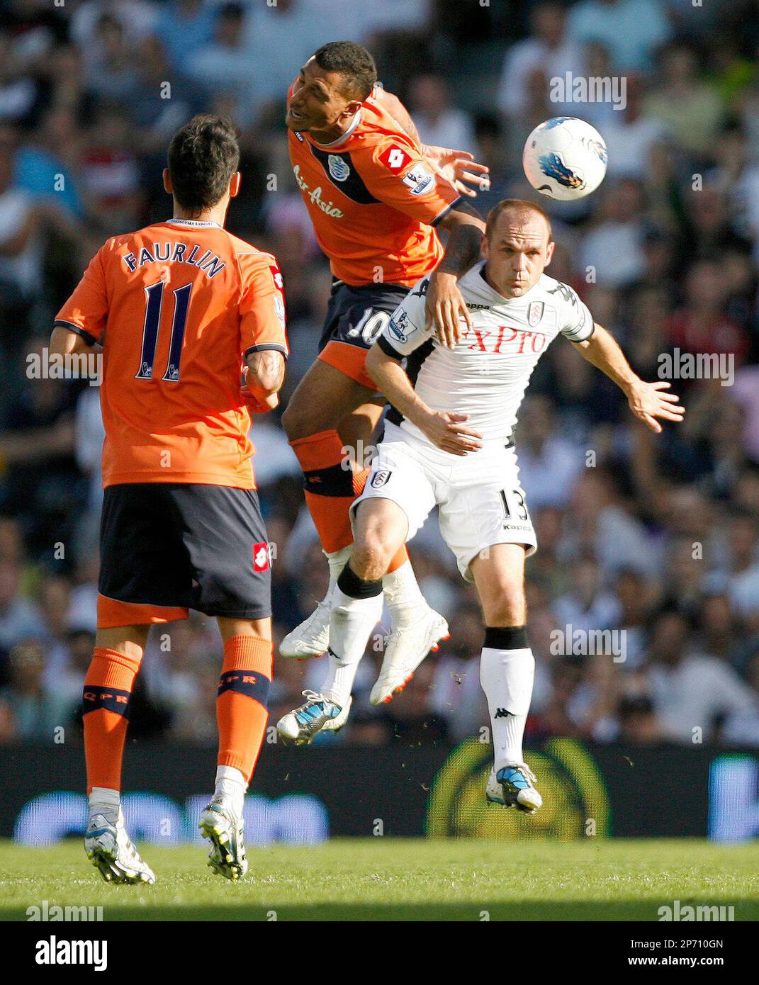 Danny Murphy of Fulham and Jay Bothroyd of Queens Park Rangers leap for ...