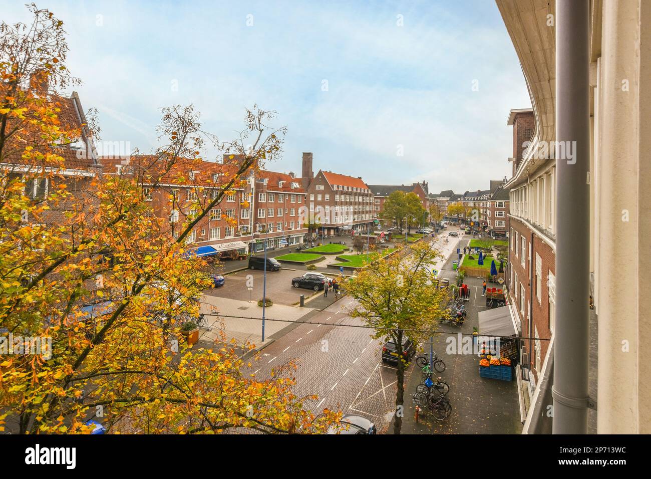 a city street with buildings and trees in the fore, taken from an open ...
