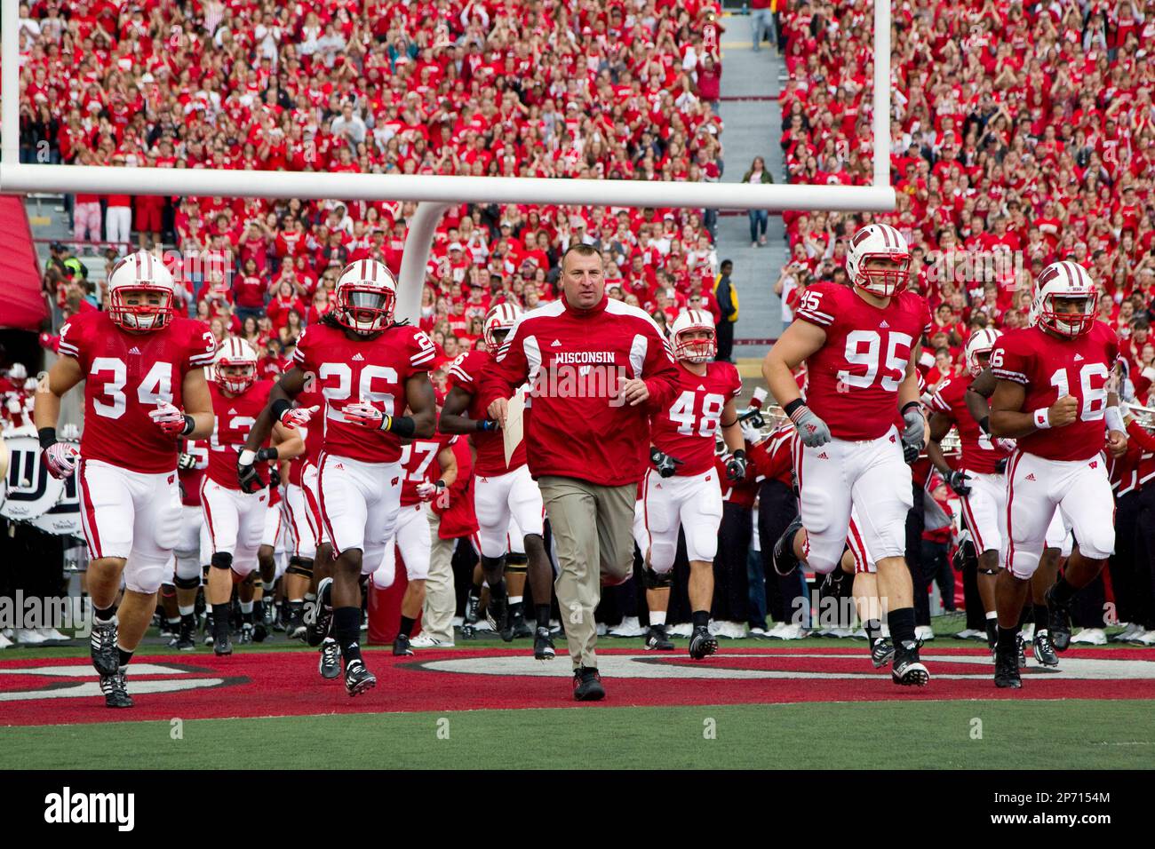 Wisconsin Badgers Head Coach Bret Bielema leads his team onto the field ...
