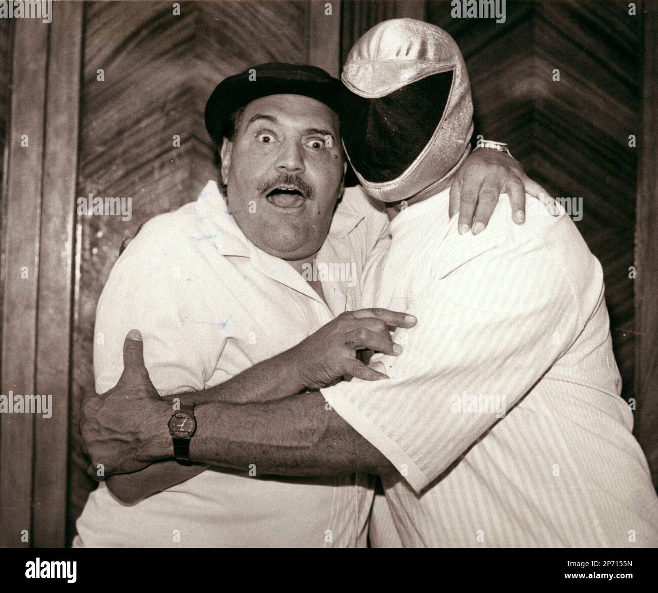 Mexican comedian Gaspar Henaine "Capulina", left, is embraced by an ...
