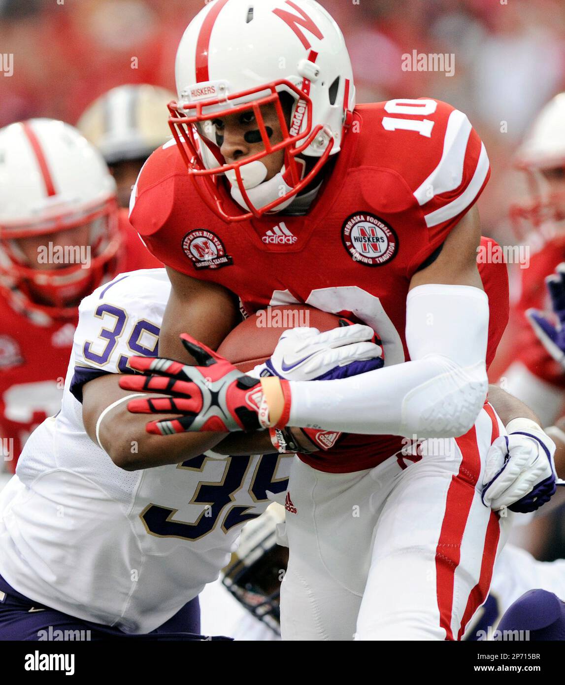 Nebraska wide receiver Jamal Turner (10) holds on tight as Washington ...