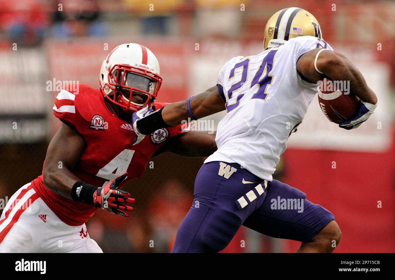 Washington running back Jesse Callier (24) tries to hold off Nebraska ...