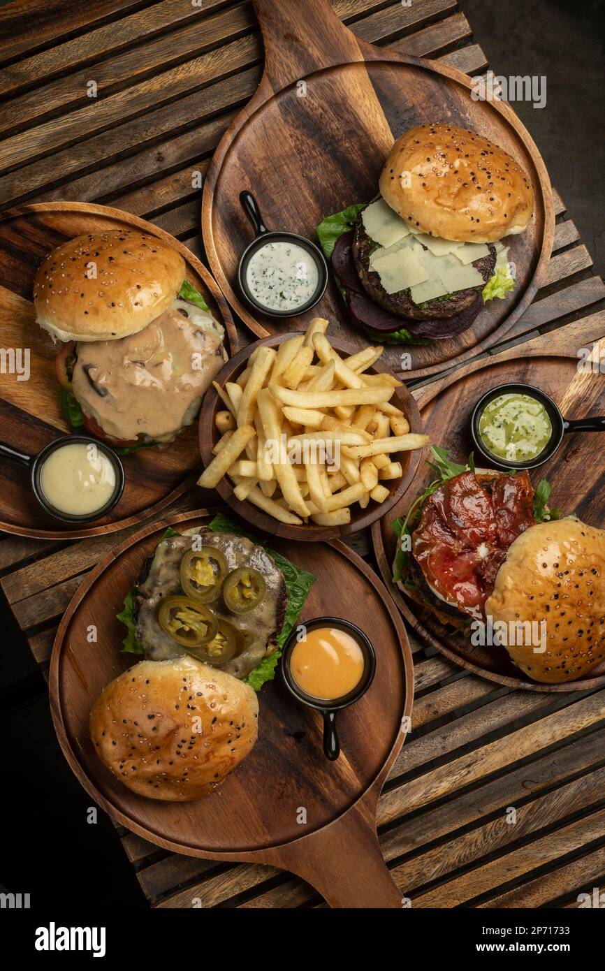 many different gourmet burgers selection on restaurant wood table Stock ...