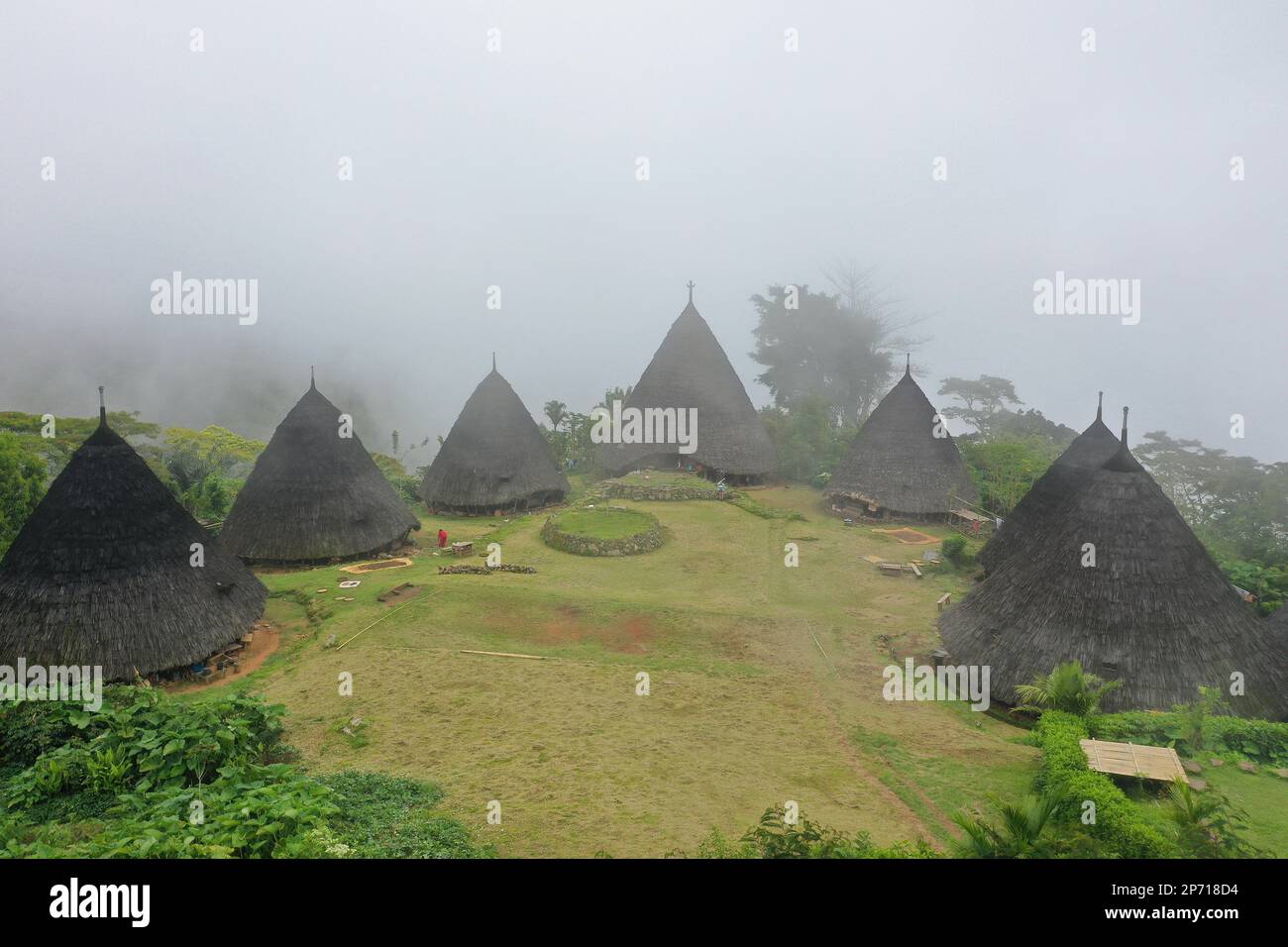 The conical thatched huts of the traditional village of Wae Rebo on ...