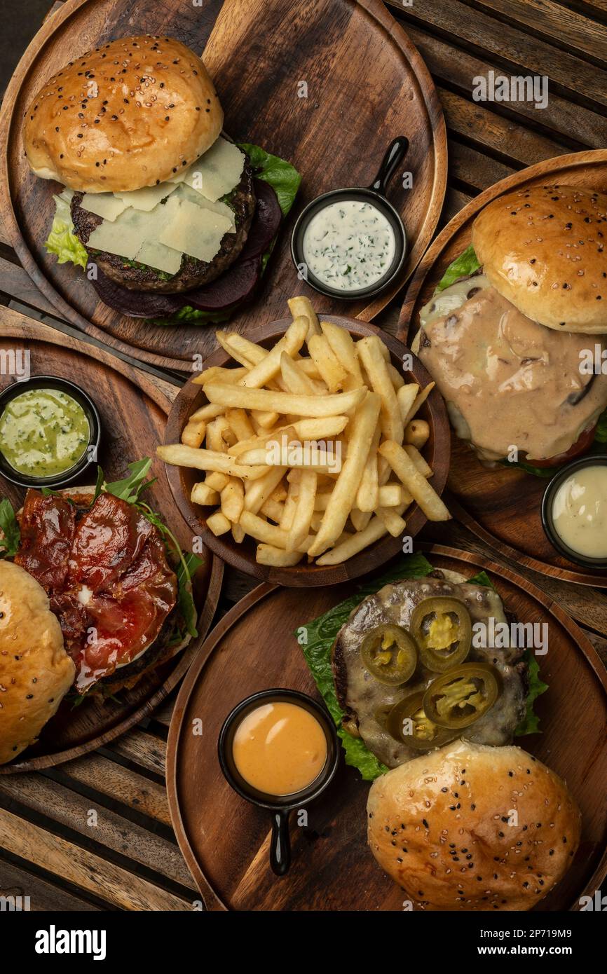many different gourmet burgers selection on restaurant wood table Stock ...