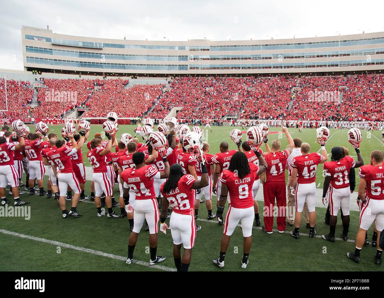 Wisconsin Badgers football team raises their helmets during the opening ...