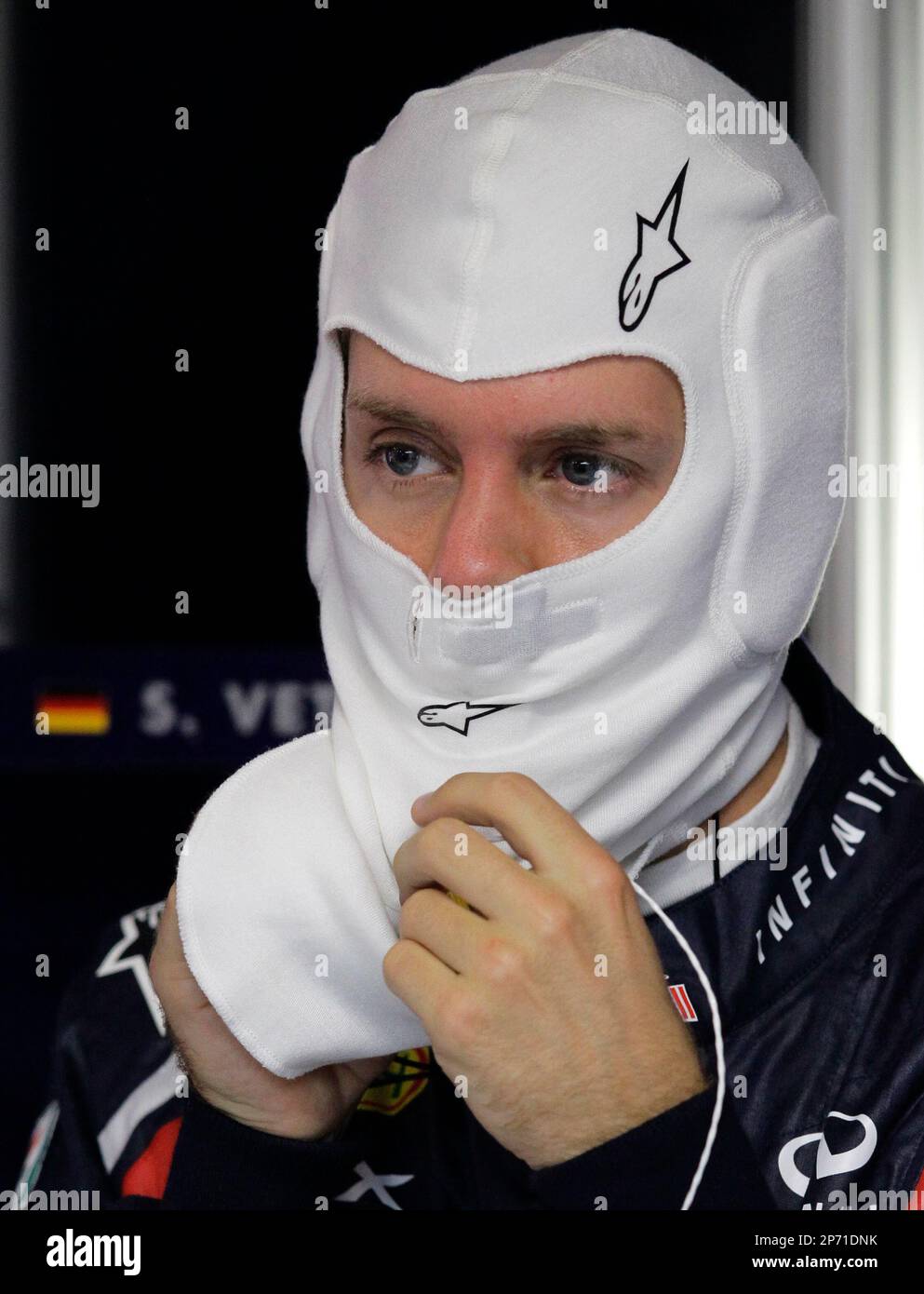 Red Bull driver Sebastian Vettel of Germany puts on his balaclava prior ...
