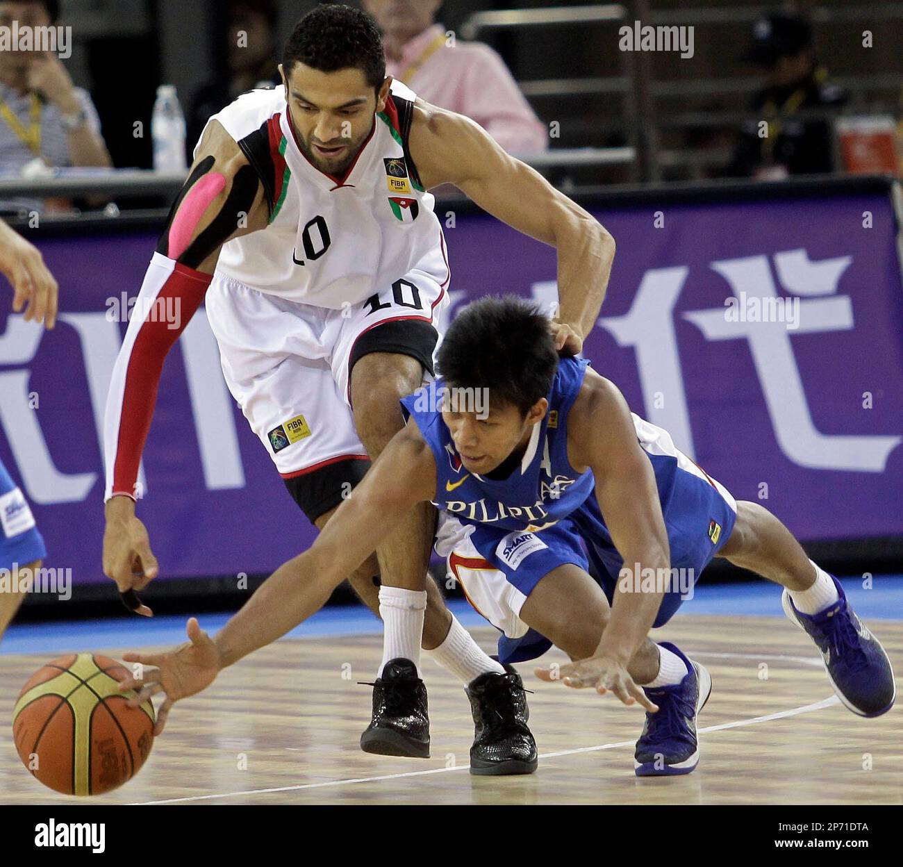 Mark Barroca of the Philippines, right, battles the ball with Jordan's ...