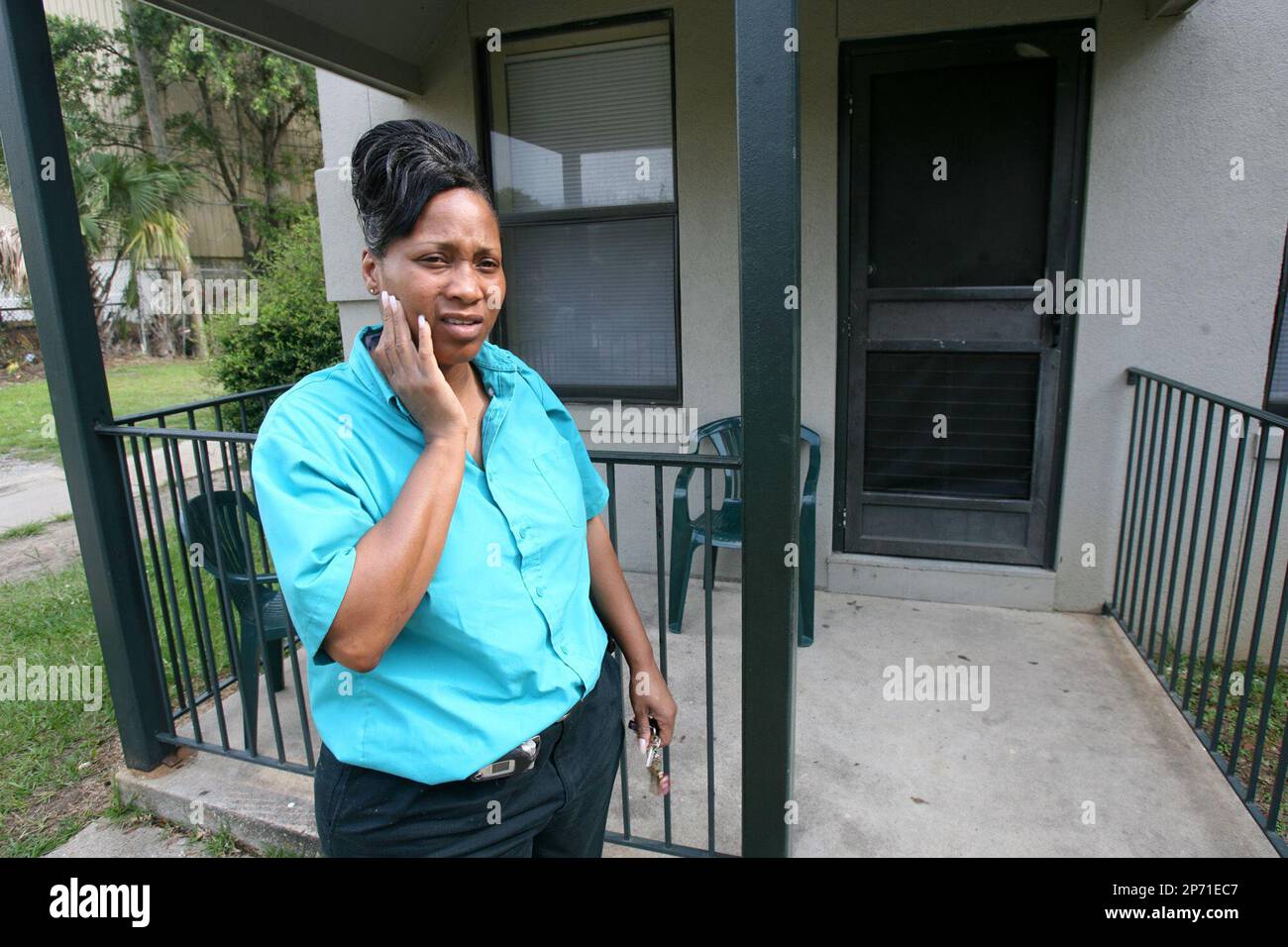 RECANTING-- Tonya Johnson, 36, stands outside an apartment in Yamacraw ...