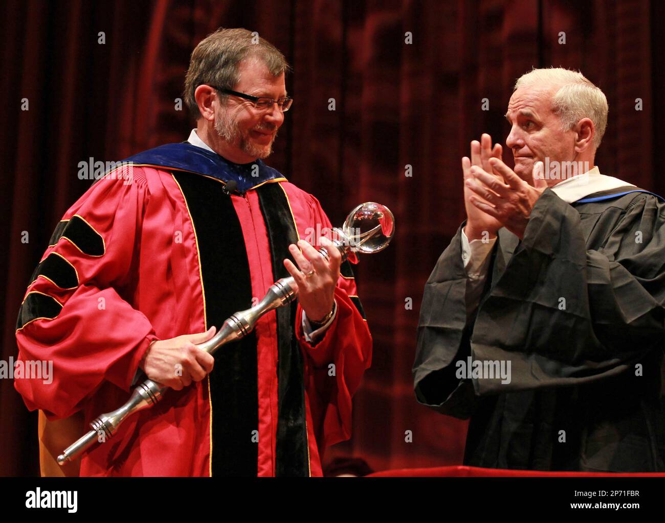 Eric Kaler, left, holds the Minnesota mace at his inaugaration as the ...