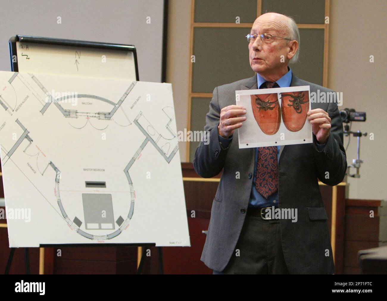 Stuart James, a blood spatter expert, holds a picture of Robert Ward's ...
