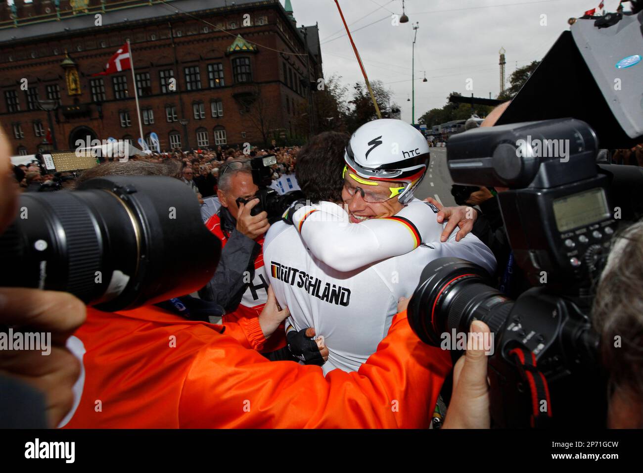 New world champion Tony Martin of Germany is hugged by a member of the ...