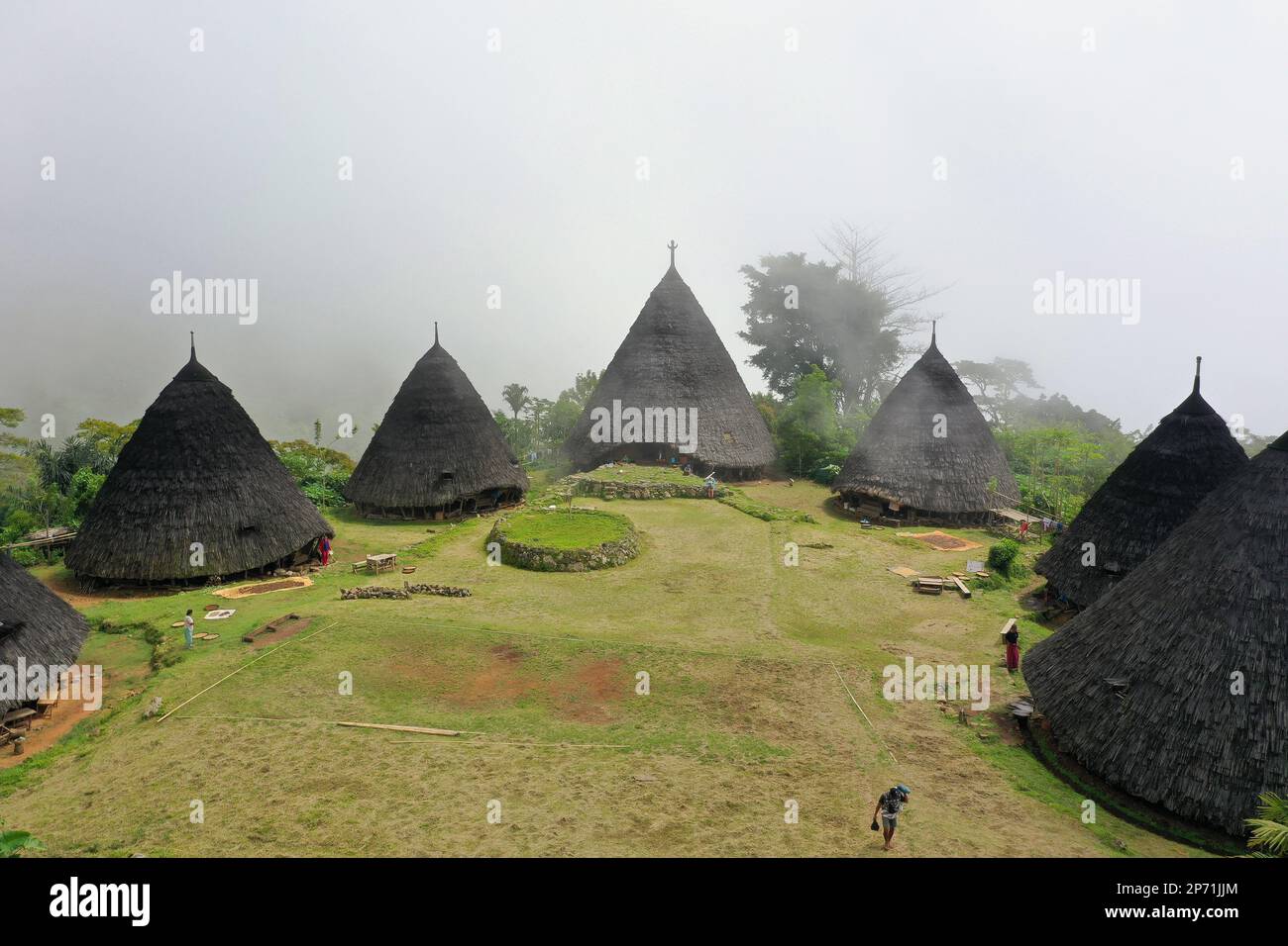 The conical thatched huts of the traditional village of Wae Rebo on ...