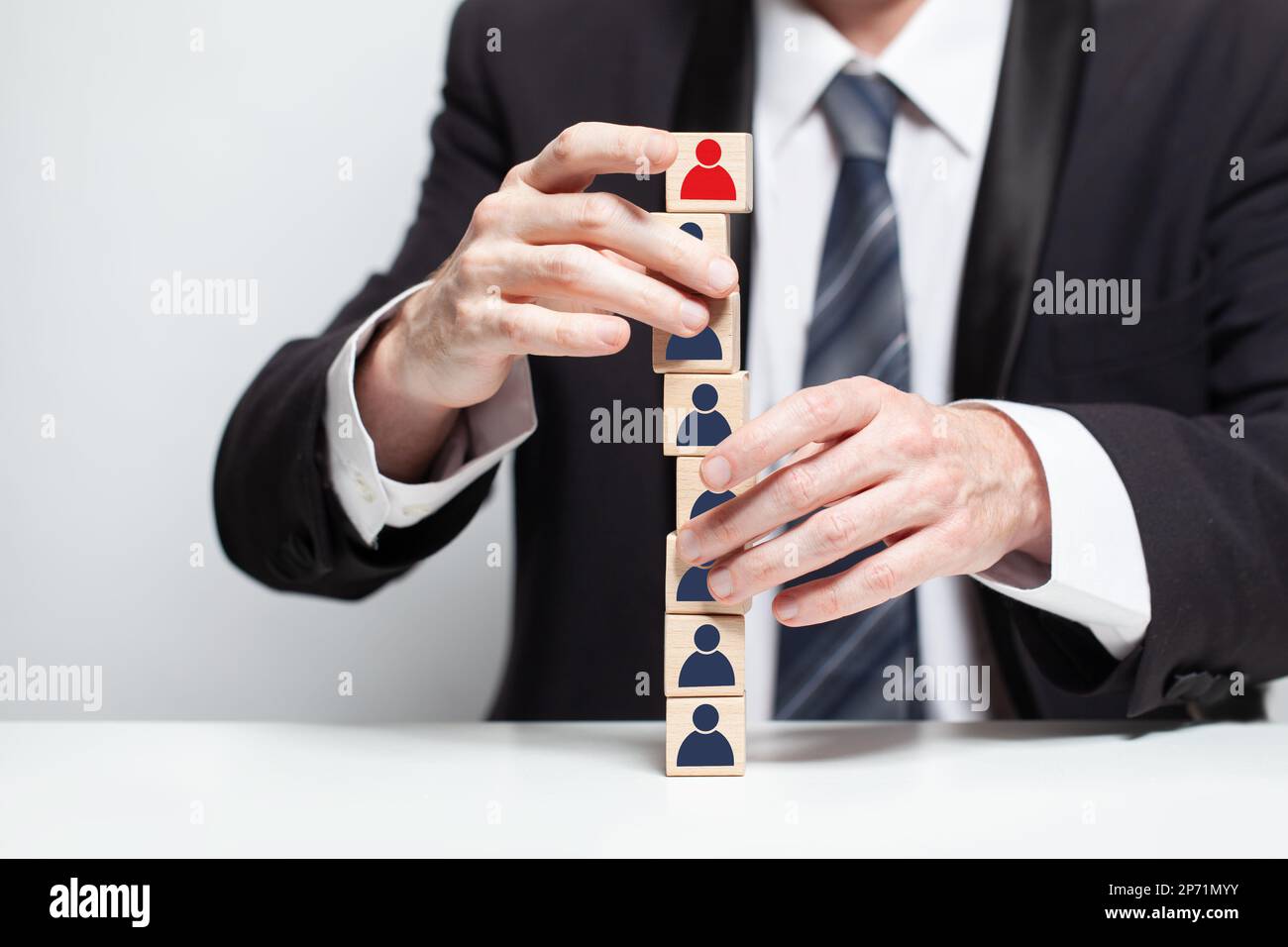 Wooden blocks with people icons and businessman hands, team, carieer ...
