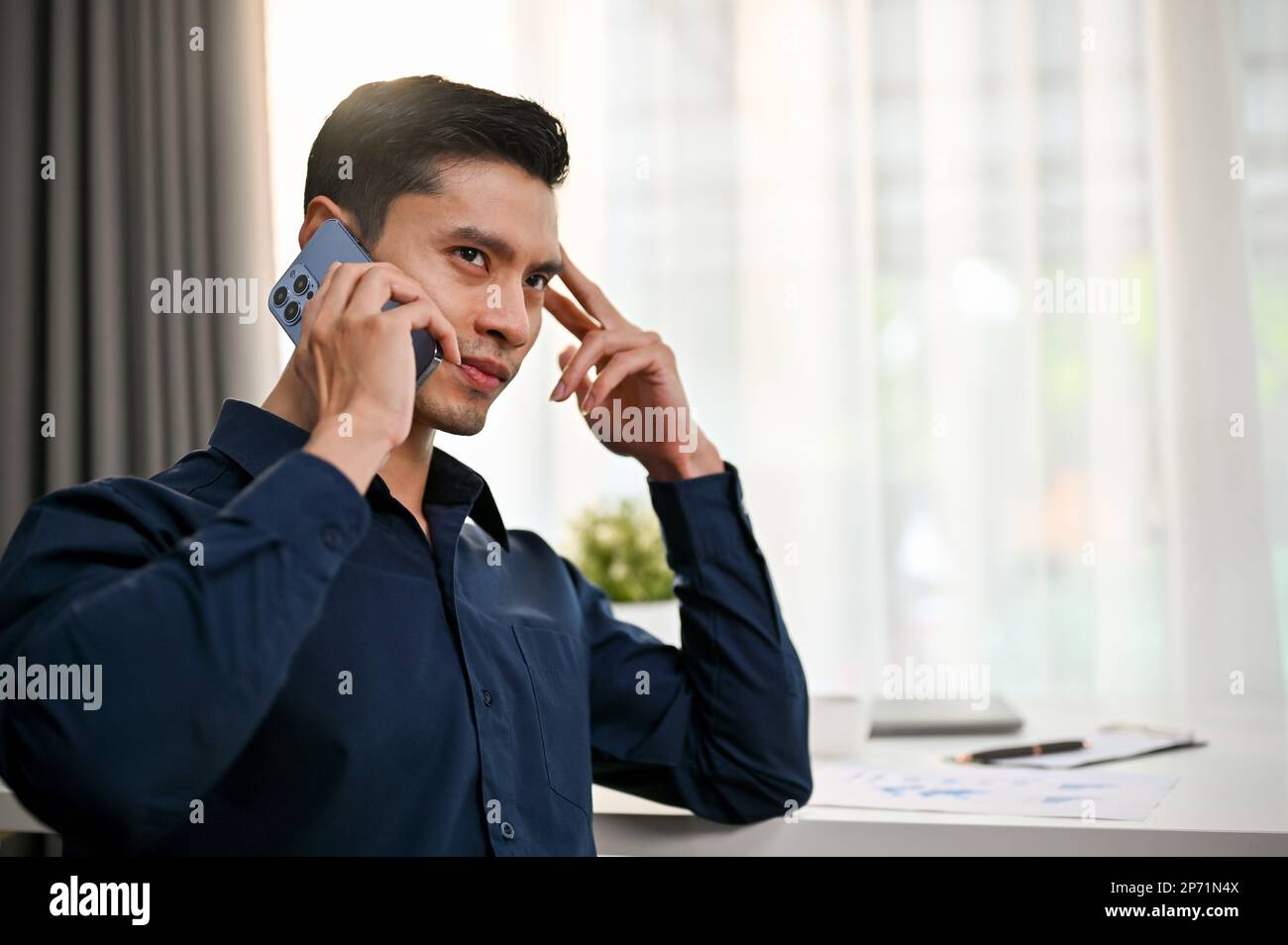 Serious and thoughtful millennial Asian businessman or male boss having ...